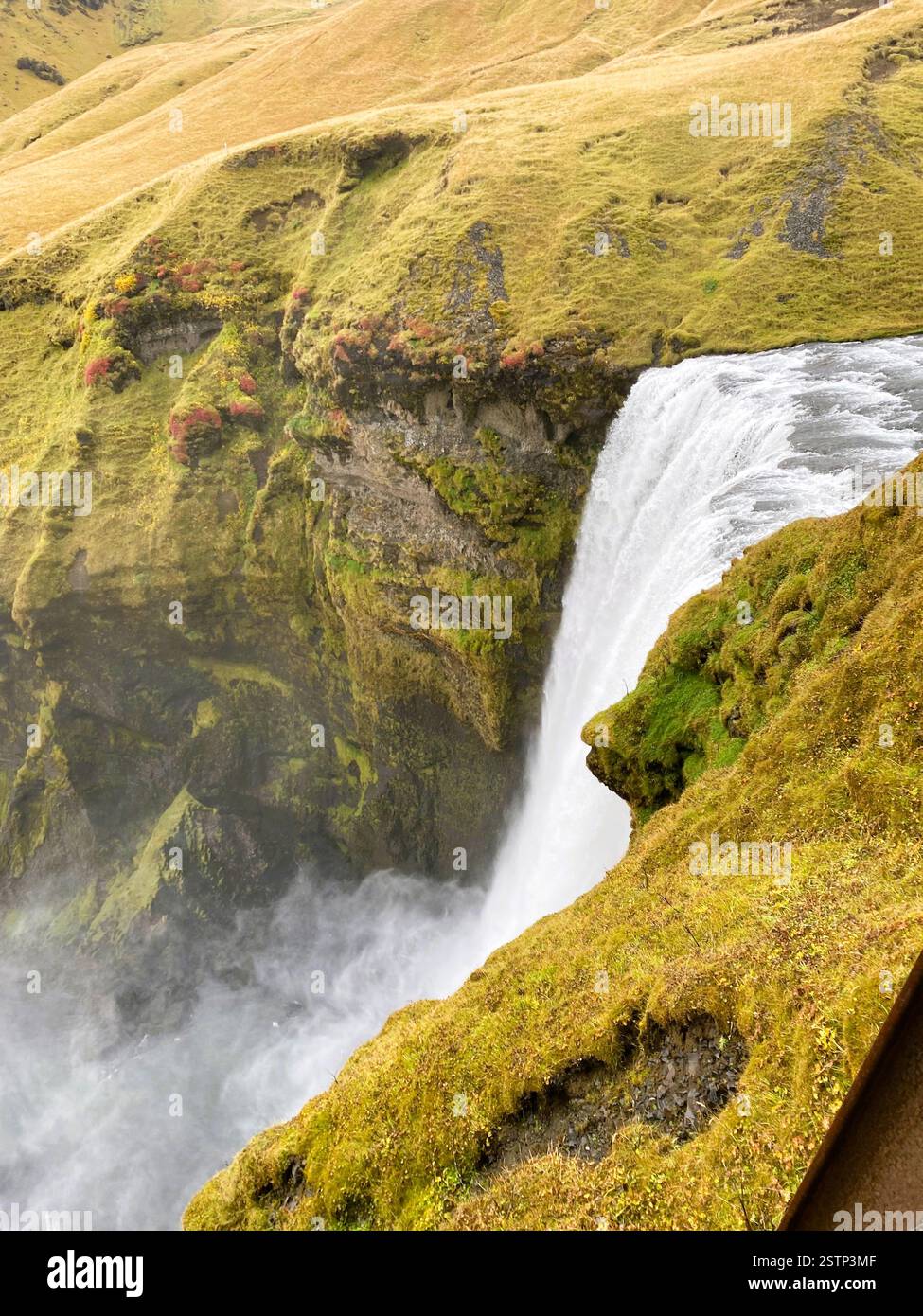 The photo captures a breathtaking view of a waterfall cascading down a ...