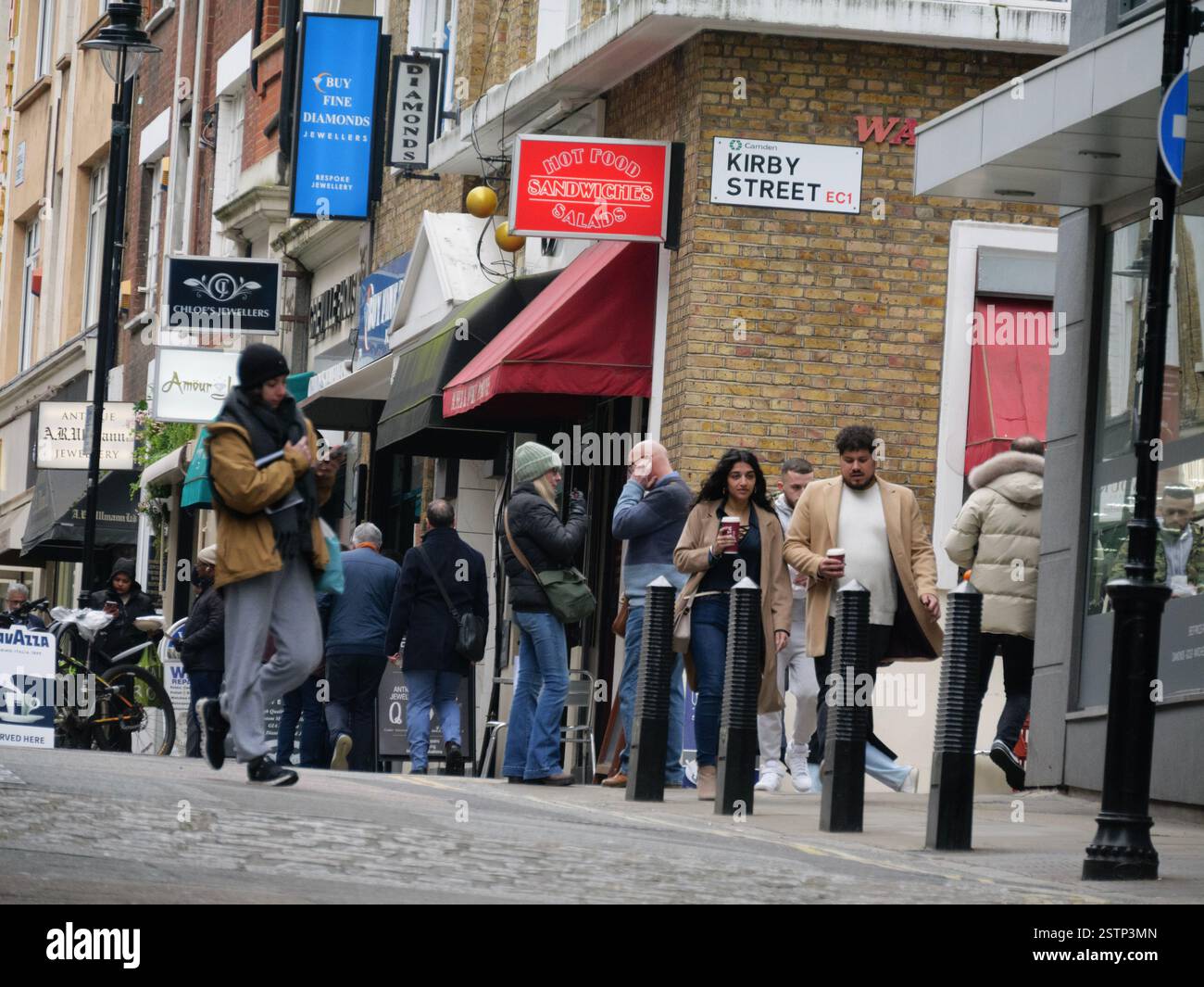 Junction of of a crowded Kirby Street and Greville Street, in London's ...