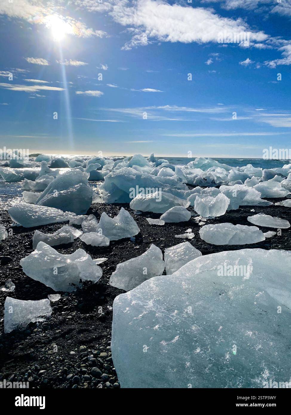 The photo captures a stunning landscape characterized by a beach strewn ...