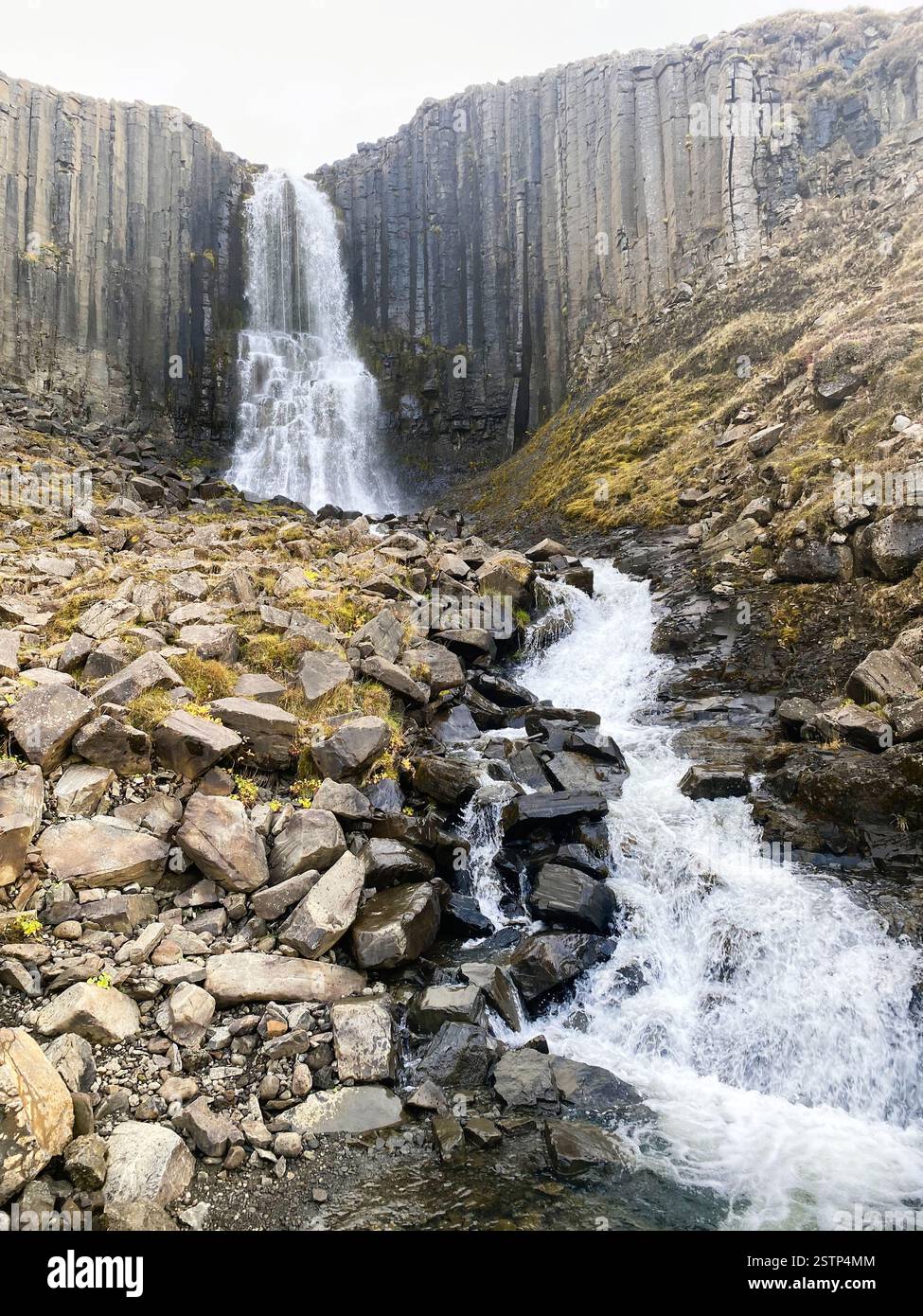 A stunning natural landscape with a waterfall cascading over unique ...