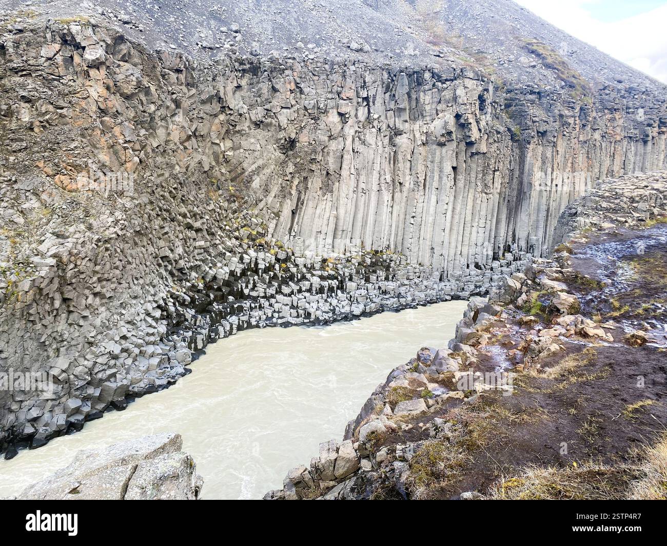 The image depicts a dramatic geological landscape characterized by ...