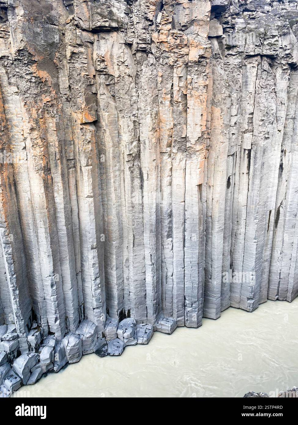 The image depicts a dramatic geological formation characterized by tall ...