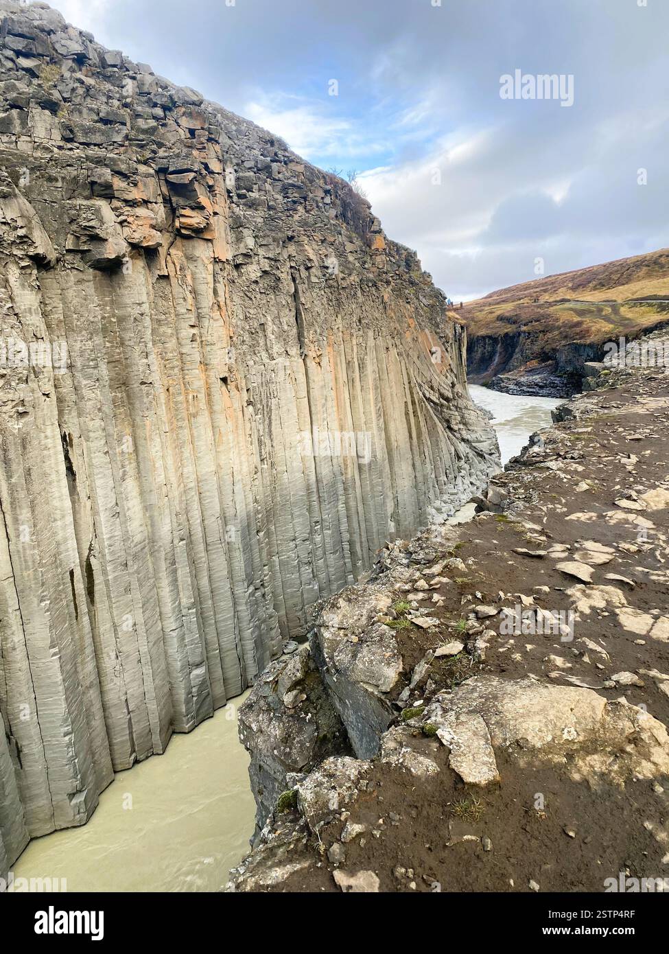 The image depicts a dramatic geological landscape characterized by ...