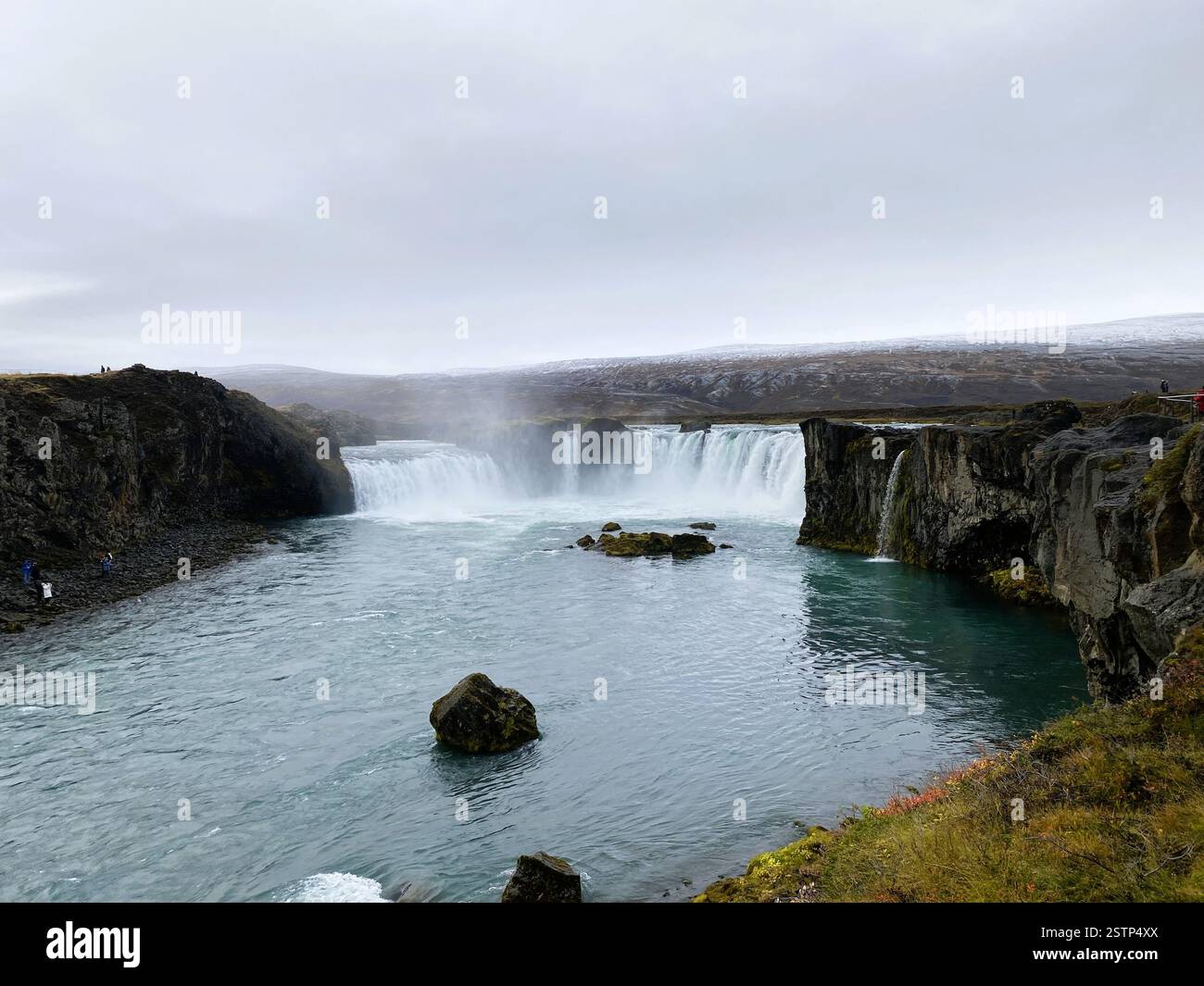 The image depicts a stunning waterfall, likely located in Iceland ...