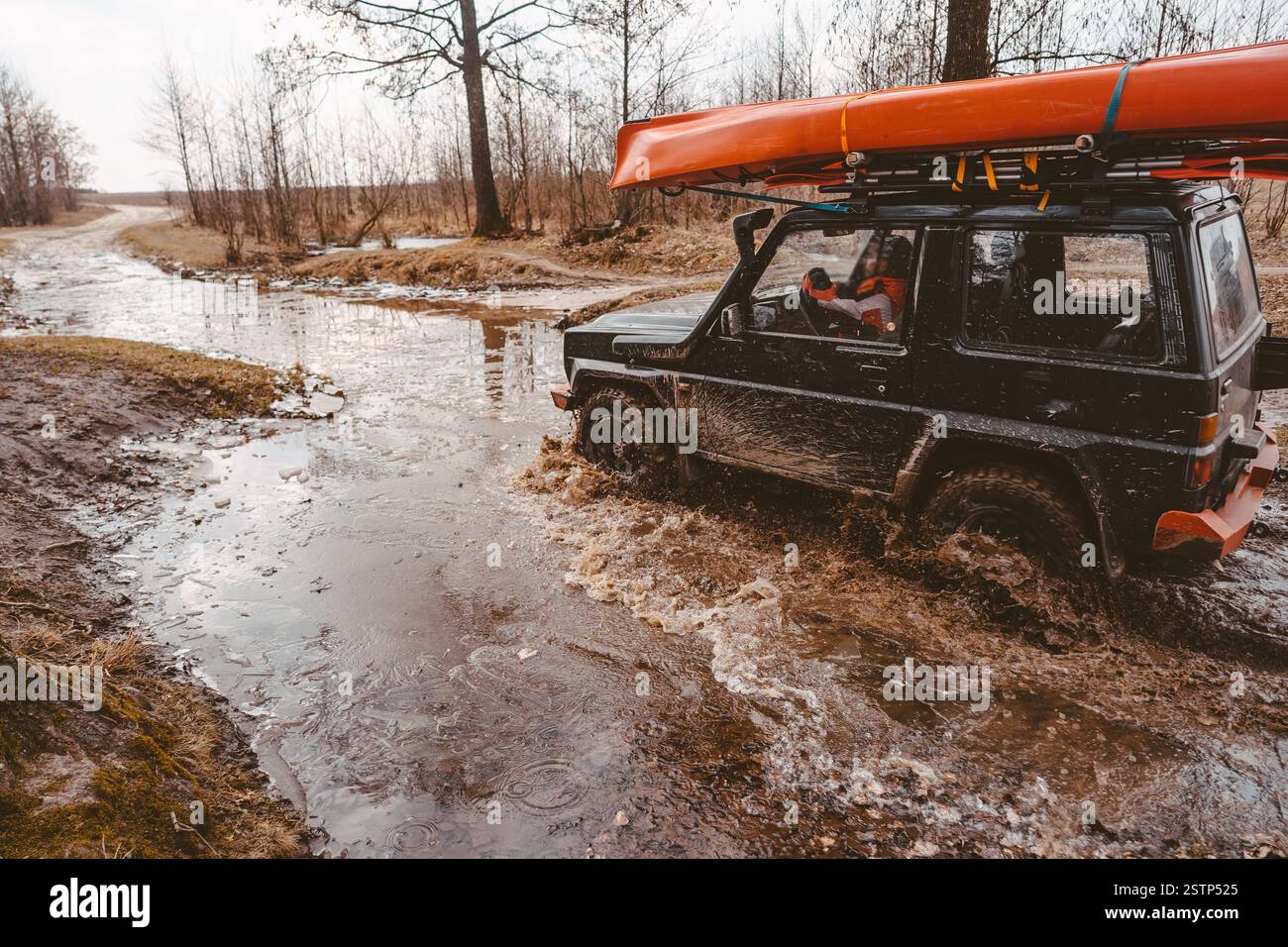 Off-road travel on dirt road road, water splash Stock Photo - Alamy
