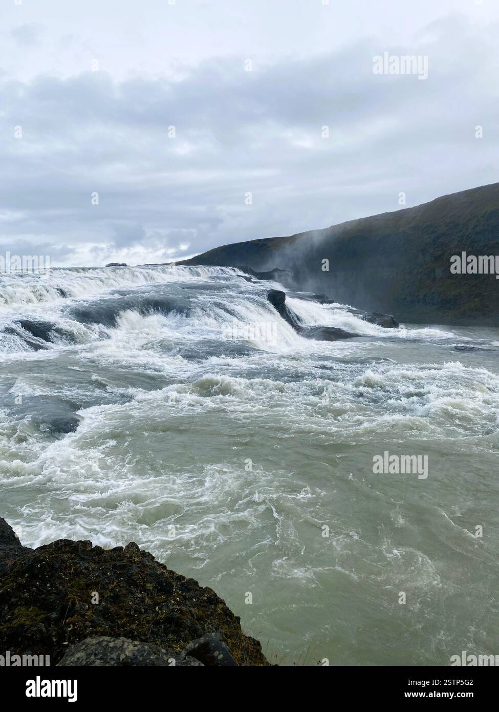 The photo captures a dramatic and powerful scene of a waterfall ...