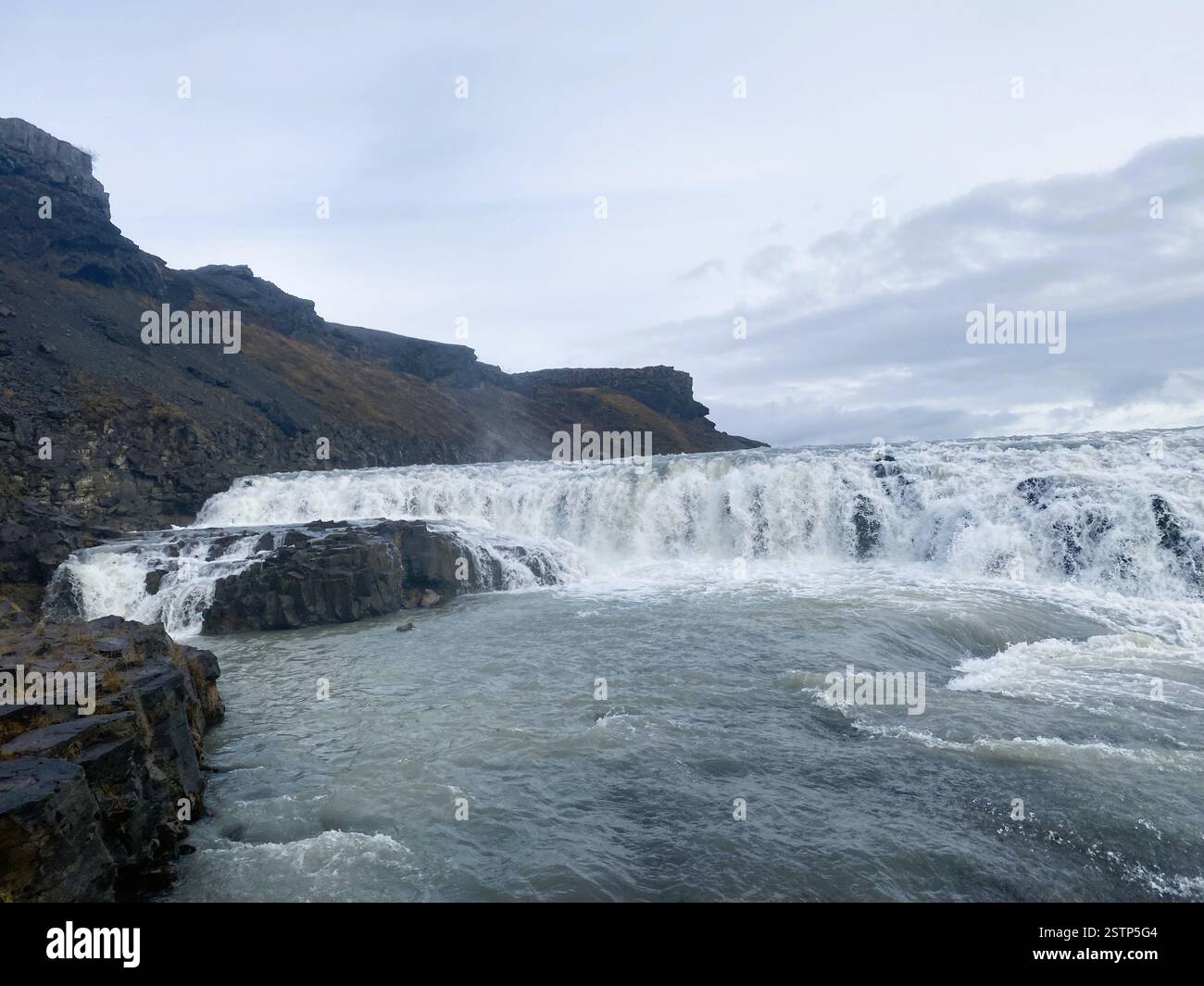 The photo captures a dramatic scene of a waterfall cascading over a ...