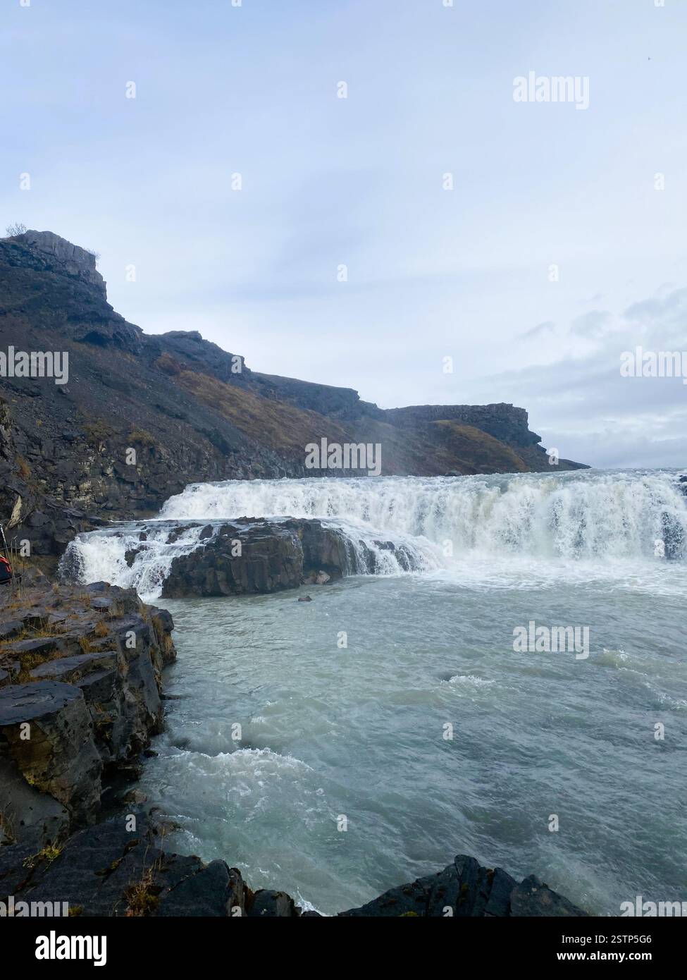 The photo captures a stunning natural landscape featuring a waterfall ...