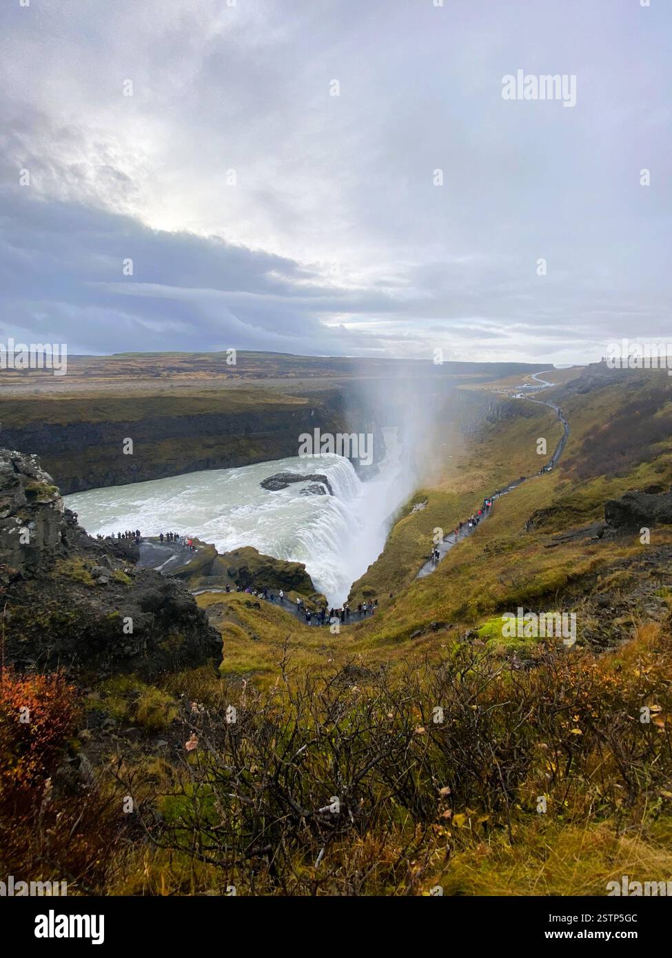 A stunning waterfall in Iceland, surrounded by rugged terrain and lush ...