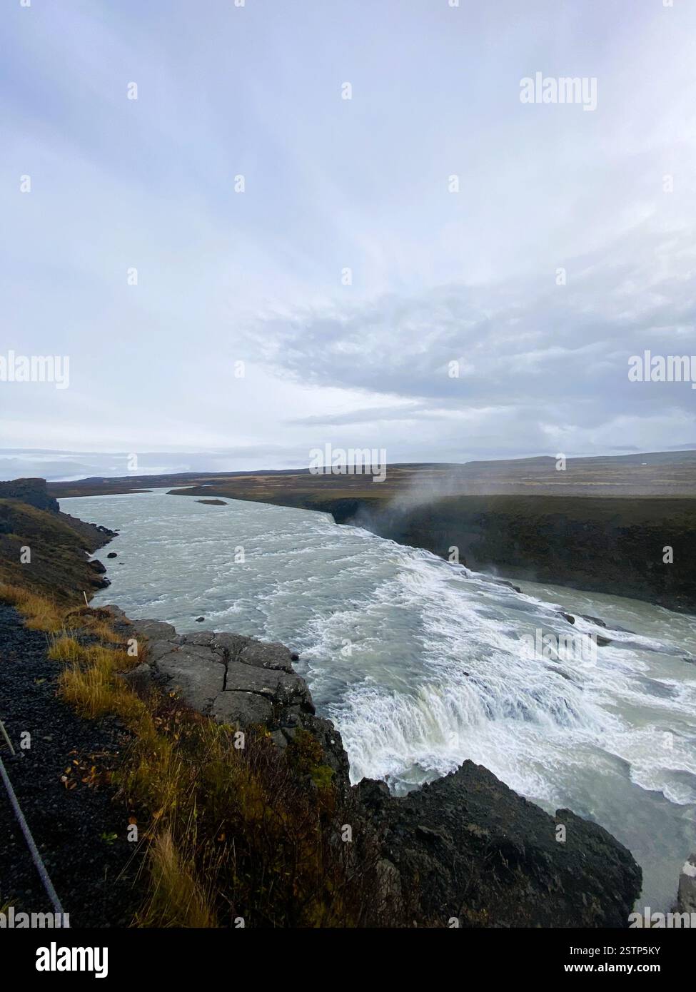 A powerful river cascading over rocky terrain, showcasing the raw ...