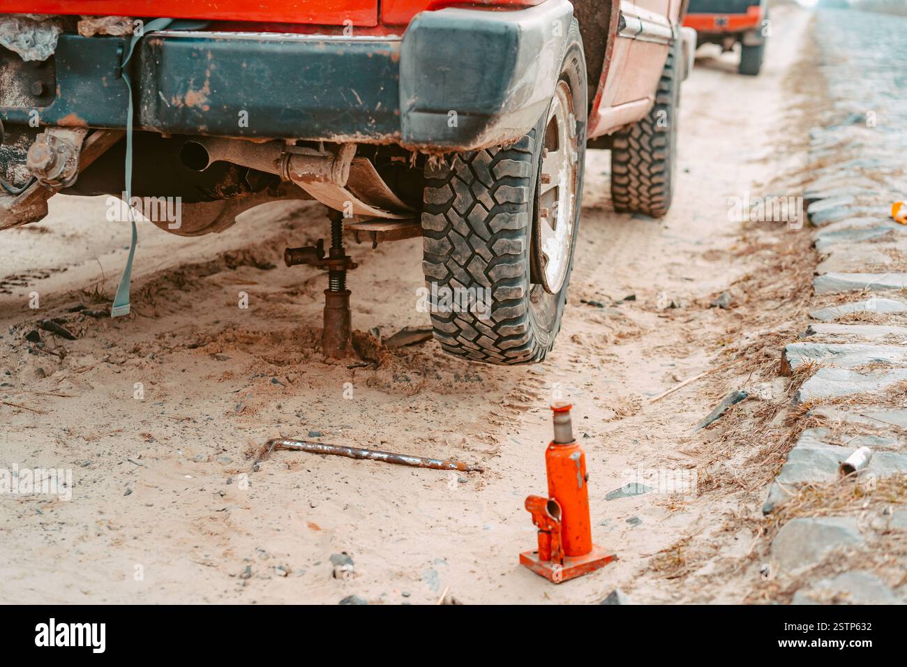 Man change the wheel manually on a 4x4 off road truck on the road Stock ...