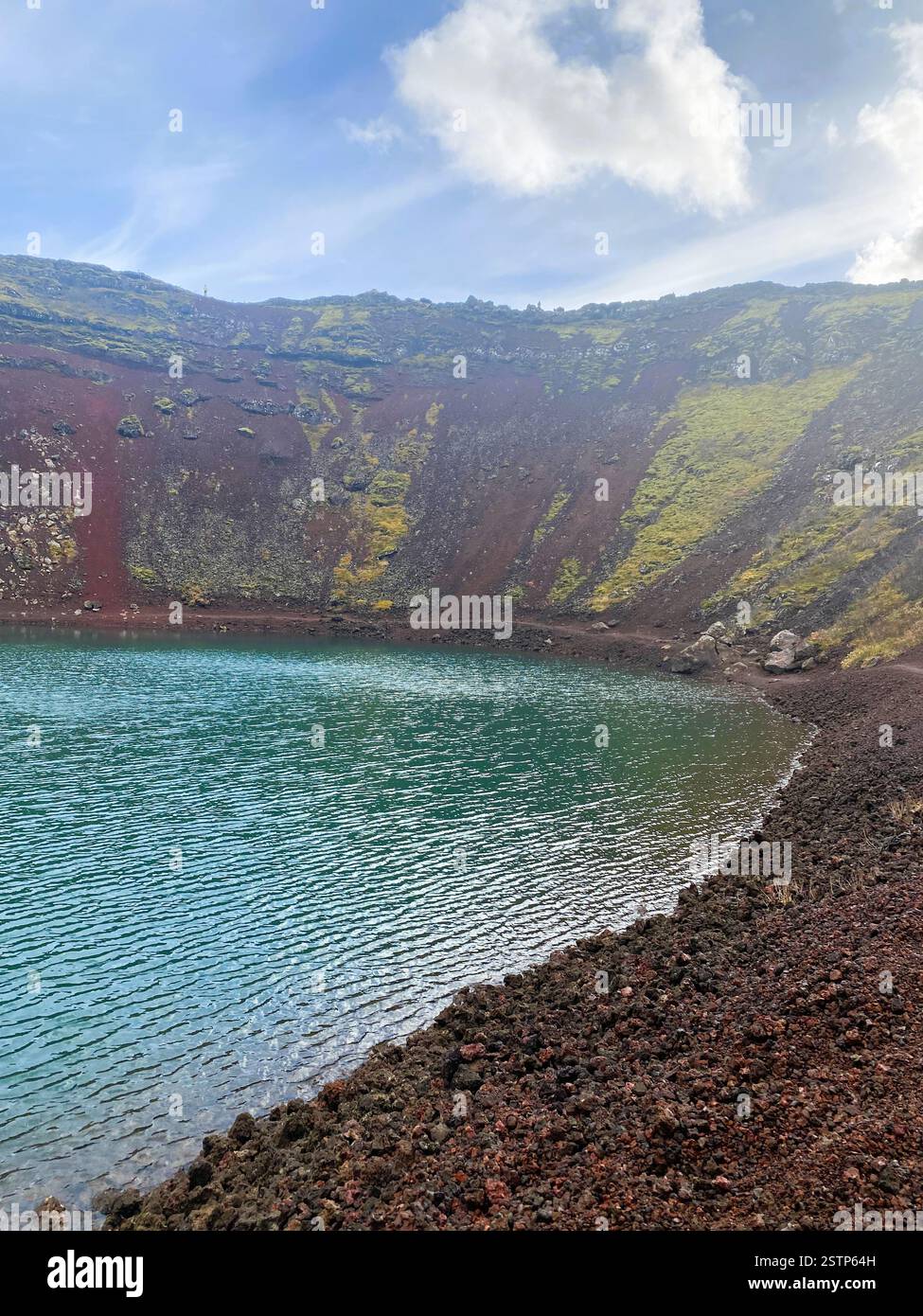 The image depicts a stunning volcanic crater with a turquoise lake at ...