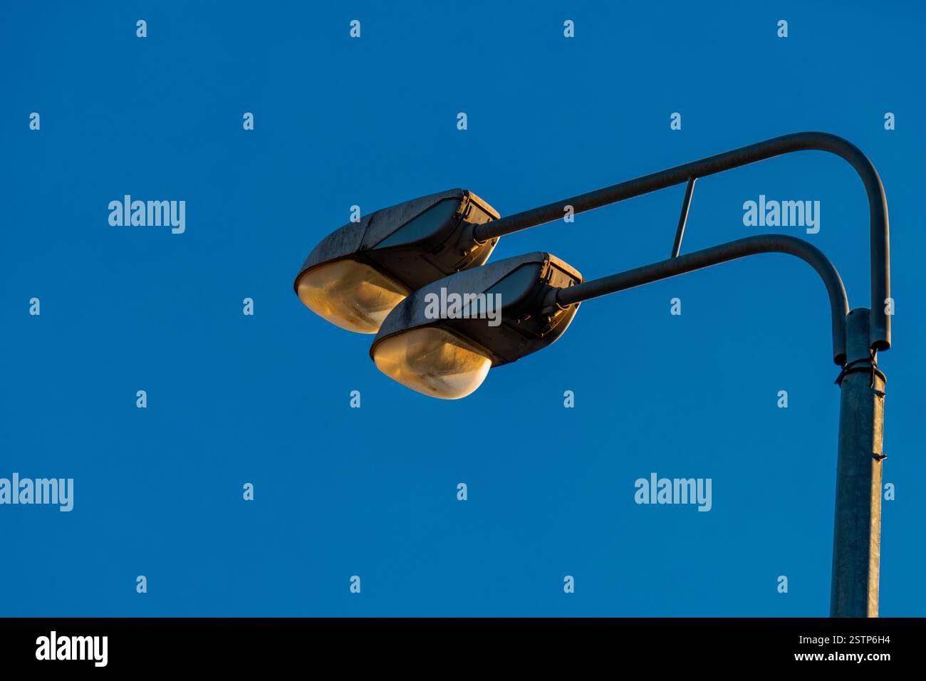 Doubled street lamp closeup in front of the clear sky Stock Photo - Alamy