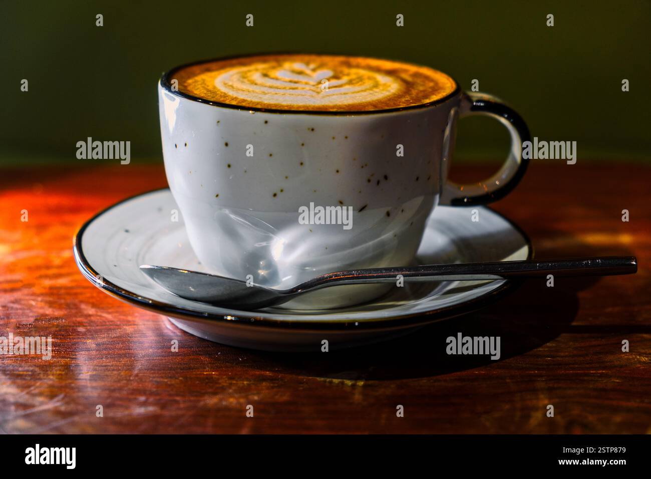 Coffee cup with cappuccino on the worn polished tabletop Stock Photo ...