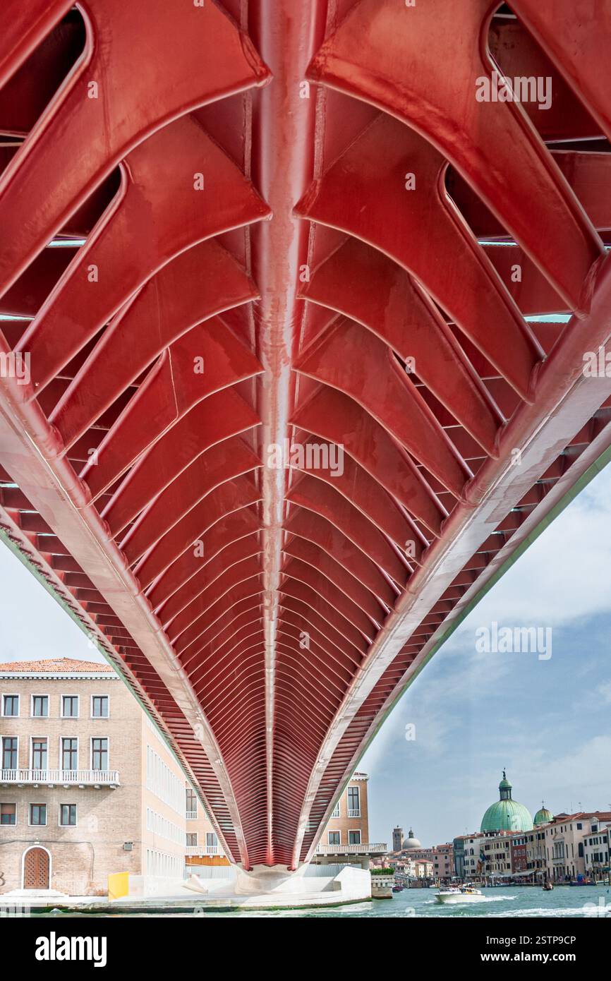Red constitution bridge in venice connecting buildings across canal ...