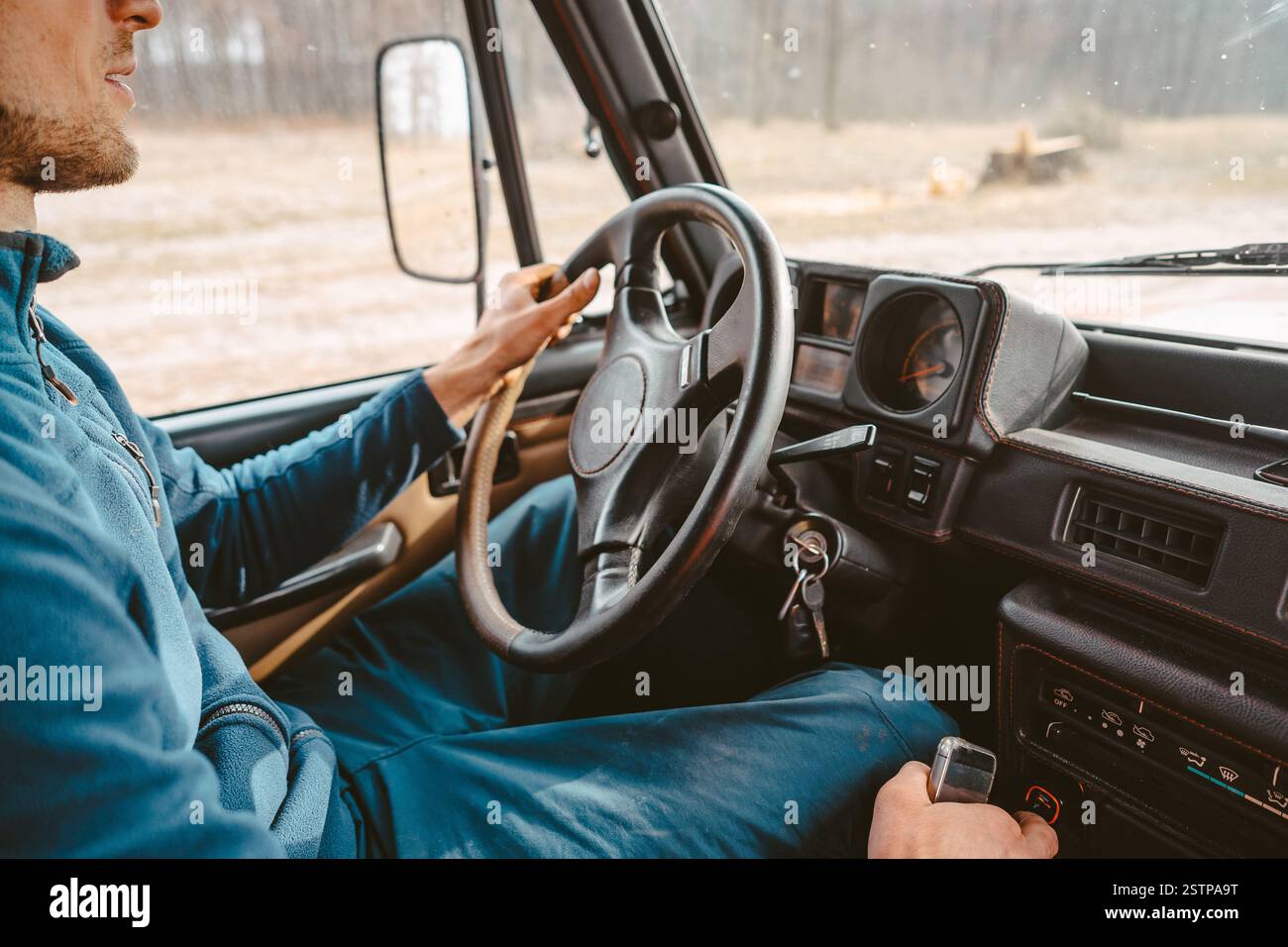 Man driving suv car by forest trail road Stock Photo - Alamy