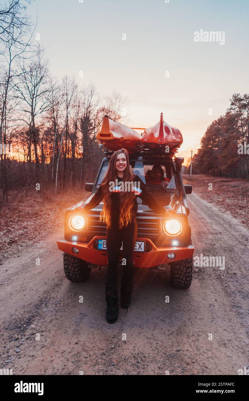 Woman stands front off 4x4 terrain vehicle Stock Photo - Alamy