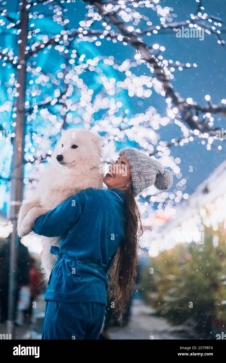 Woman carries dog in arms hi-res stock photography and images - Alamy