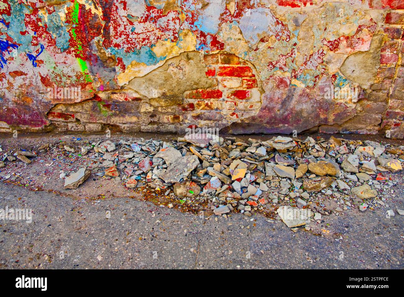 Damaged wall with building garbage beneath Stock Photo - Alamy
