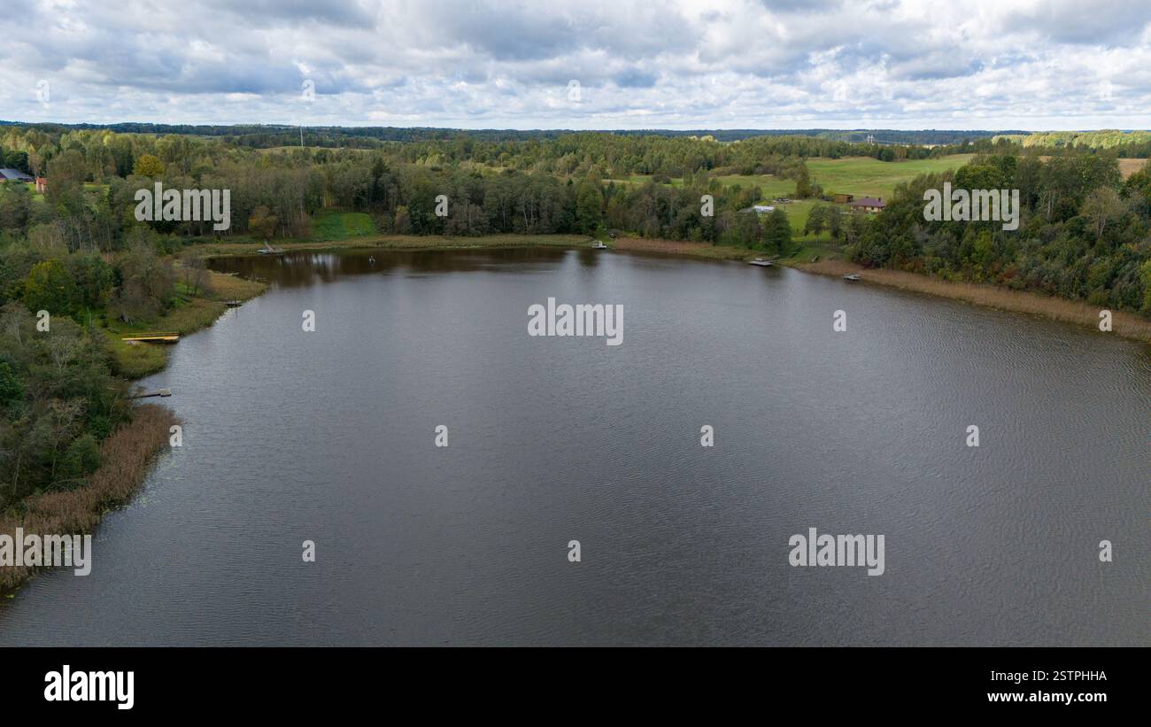 Aerial view of a serene lake surrounded by lush green forests and ...