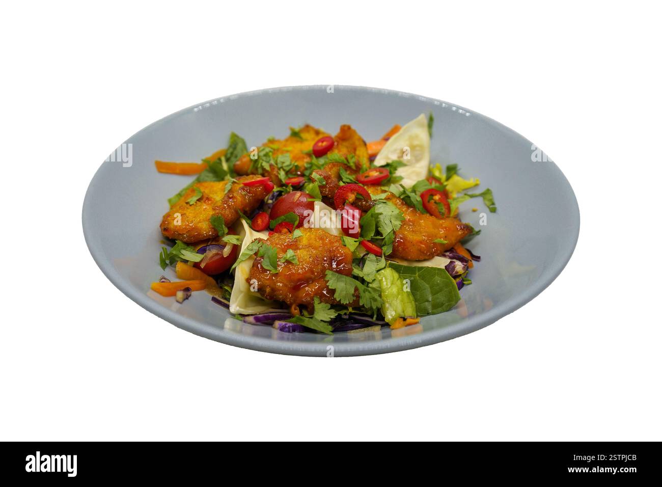 Asian-style crispy chicken salad with gyoza dumplings. Isolated on ...