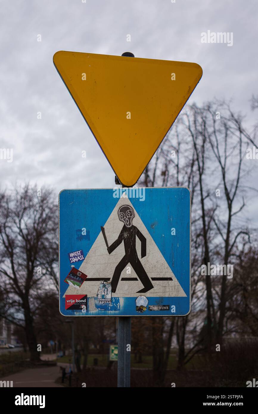 Warsaw, Poland. January 26, 2025 - Blue crosswalk sign with stickers ...