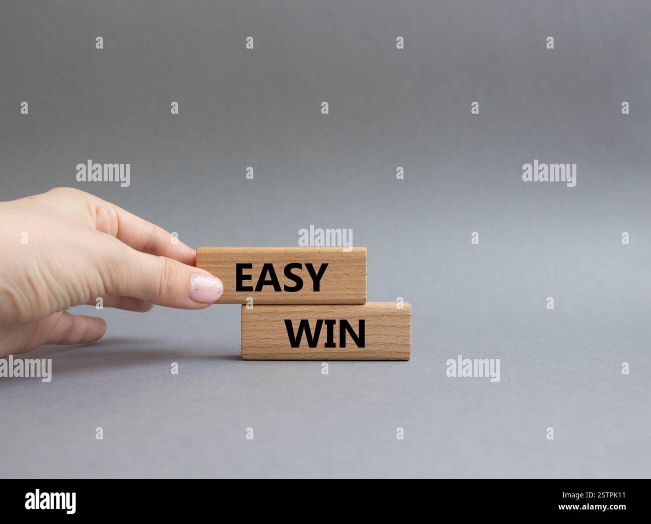 Easy win symbol. Wooden blocks with words Easy win. Beautiful grey ...