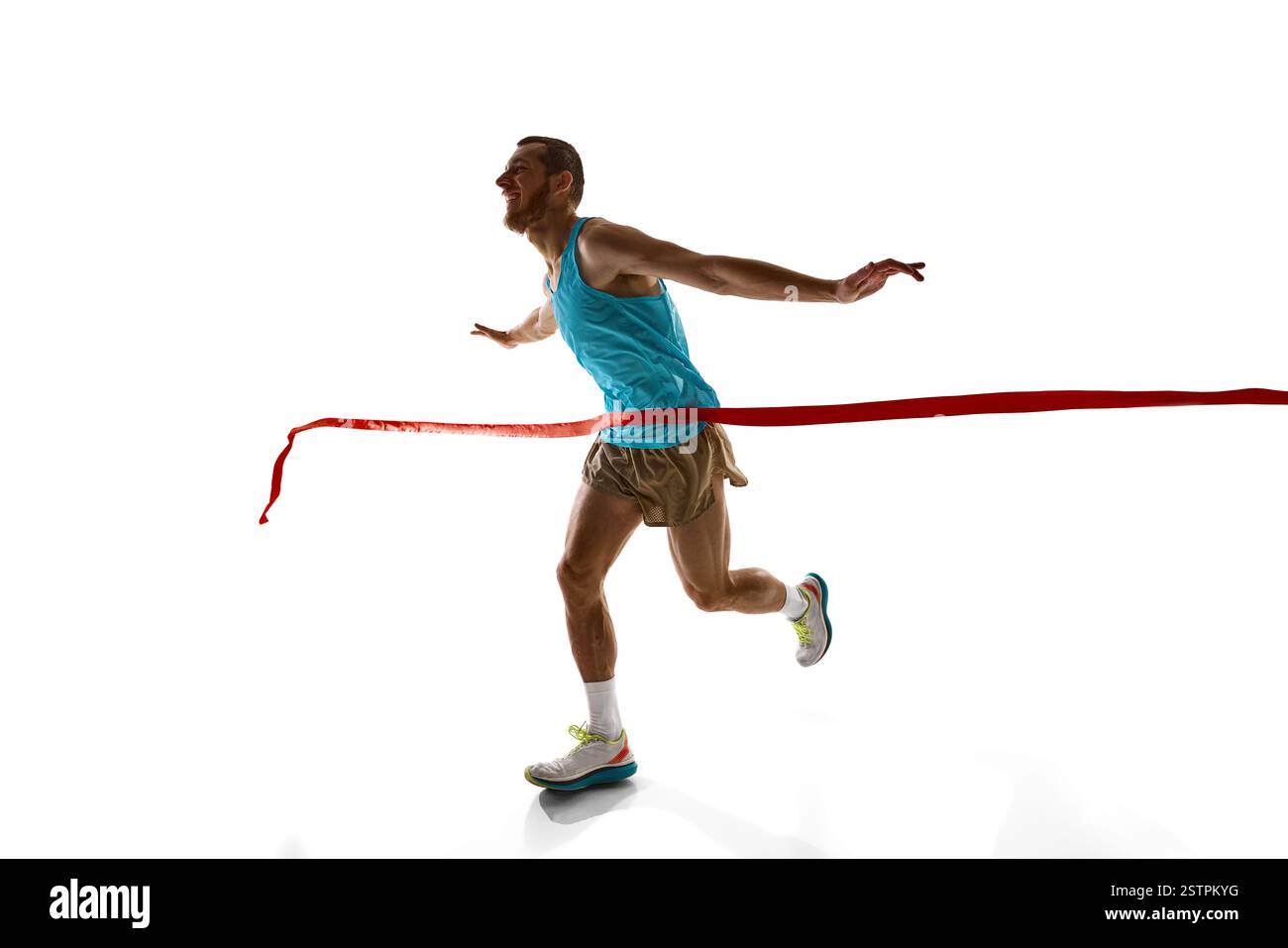 Dynamic photo of young man, runner breaking red ribbon, ultimate ...