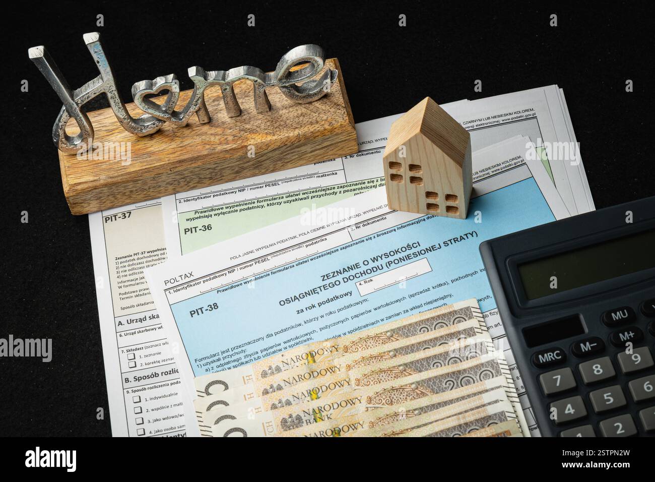 Piles of Polish Pit Tax forms lie on a desk, surrounded by 100 zloty ...