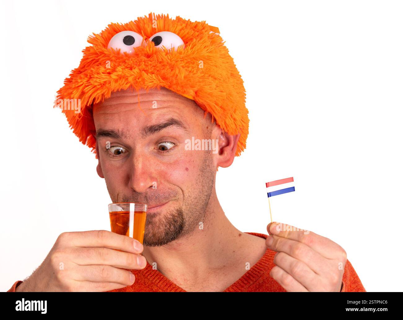 Dutch man dressed in festive orange clothes drinks and celebrates King ...