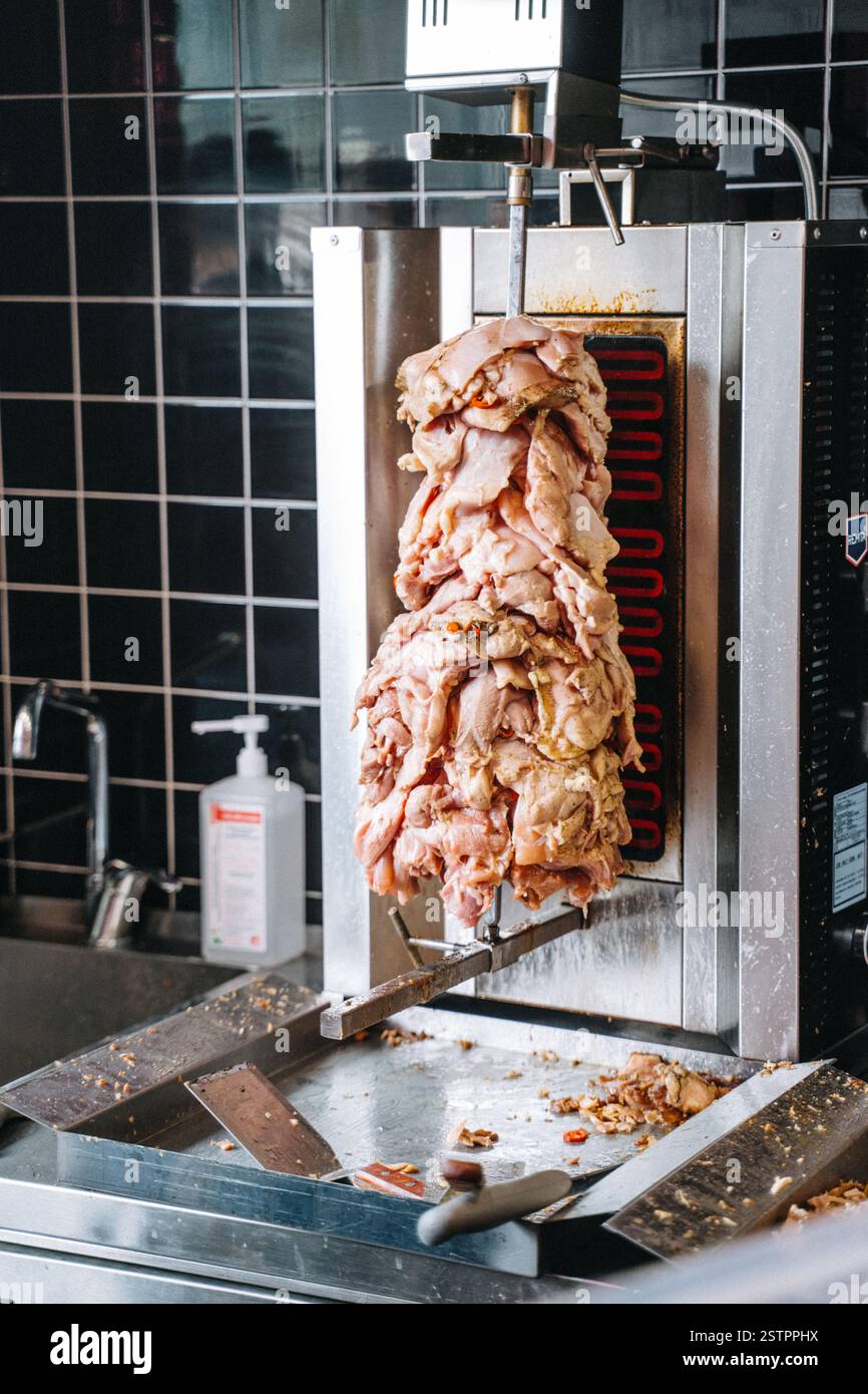 Doner kebab on rotating vertical spit. Street food, fast food concep ...