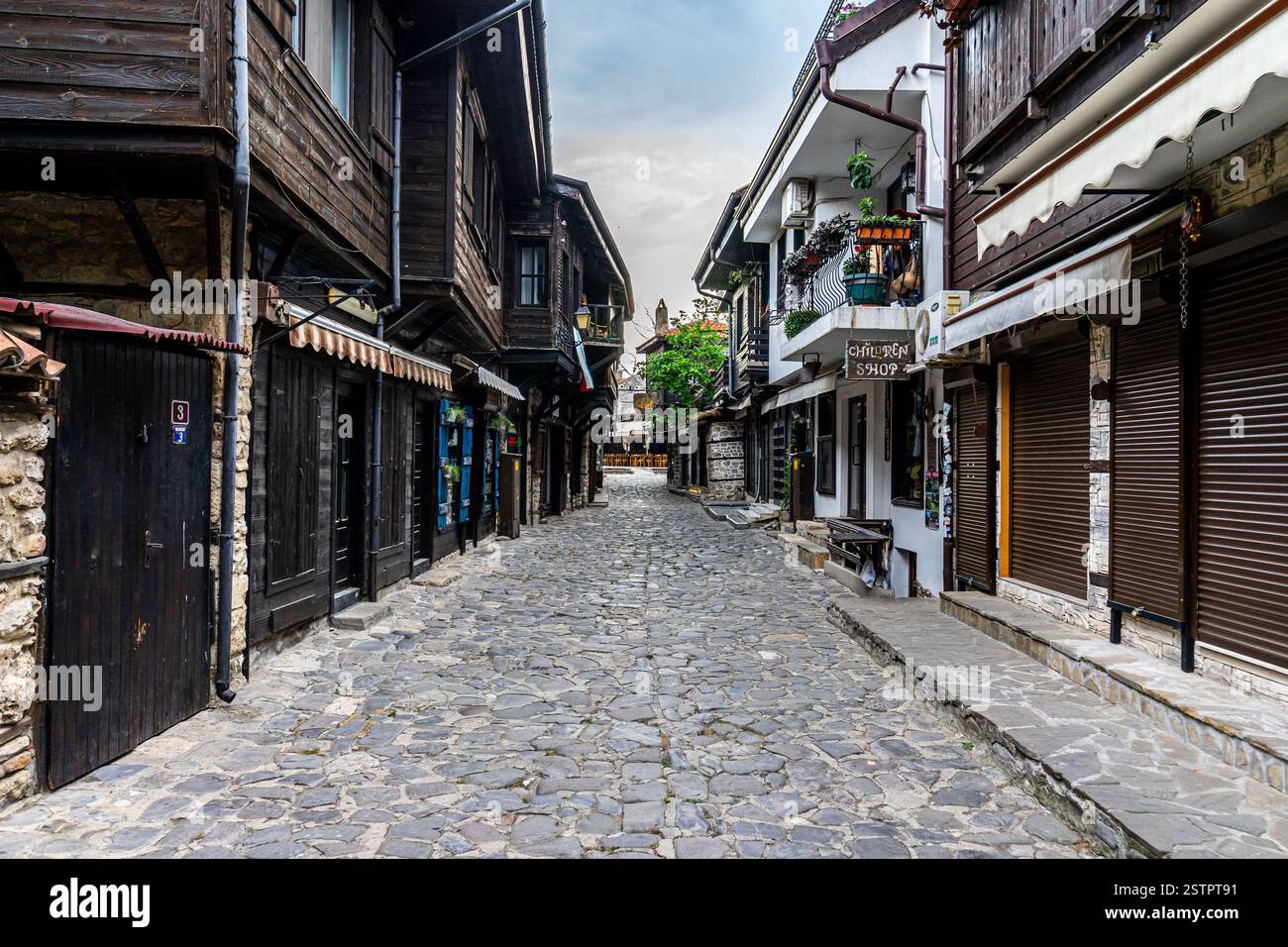 Beautiful and narrow street with restaurants, cafes and shops of the ...