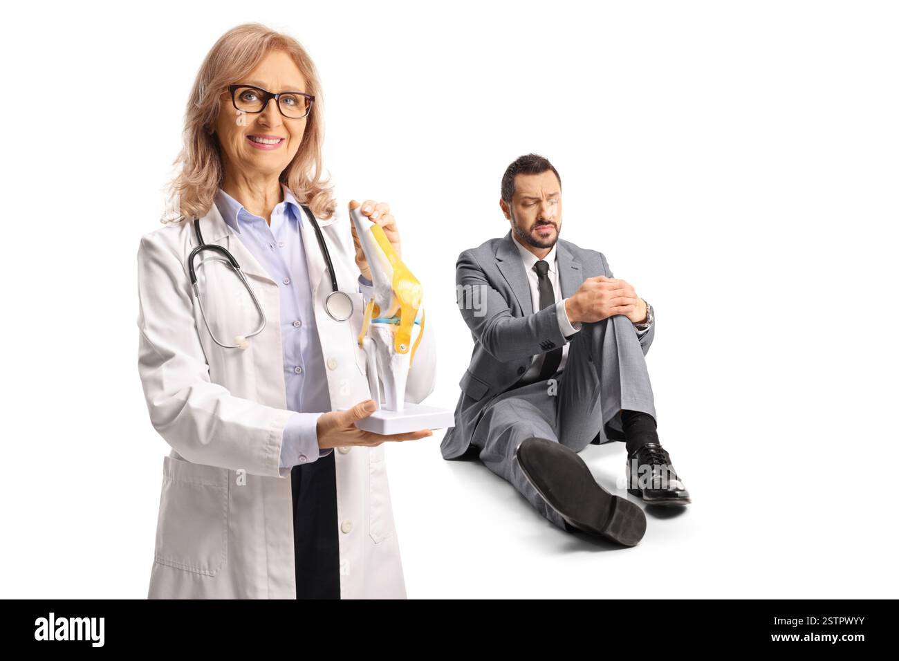Doctor holding a knee bone model and man sitting with a knee injury ...