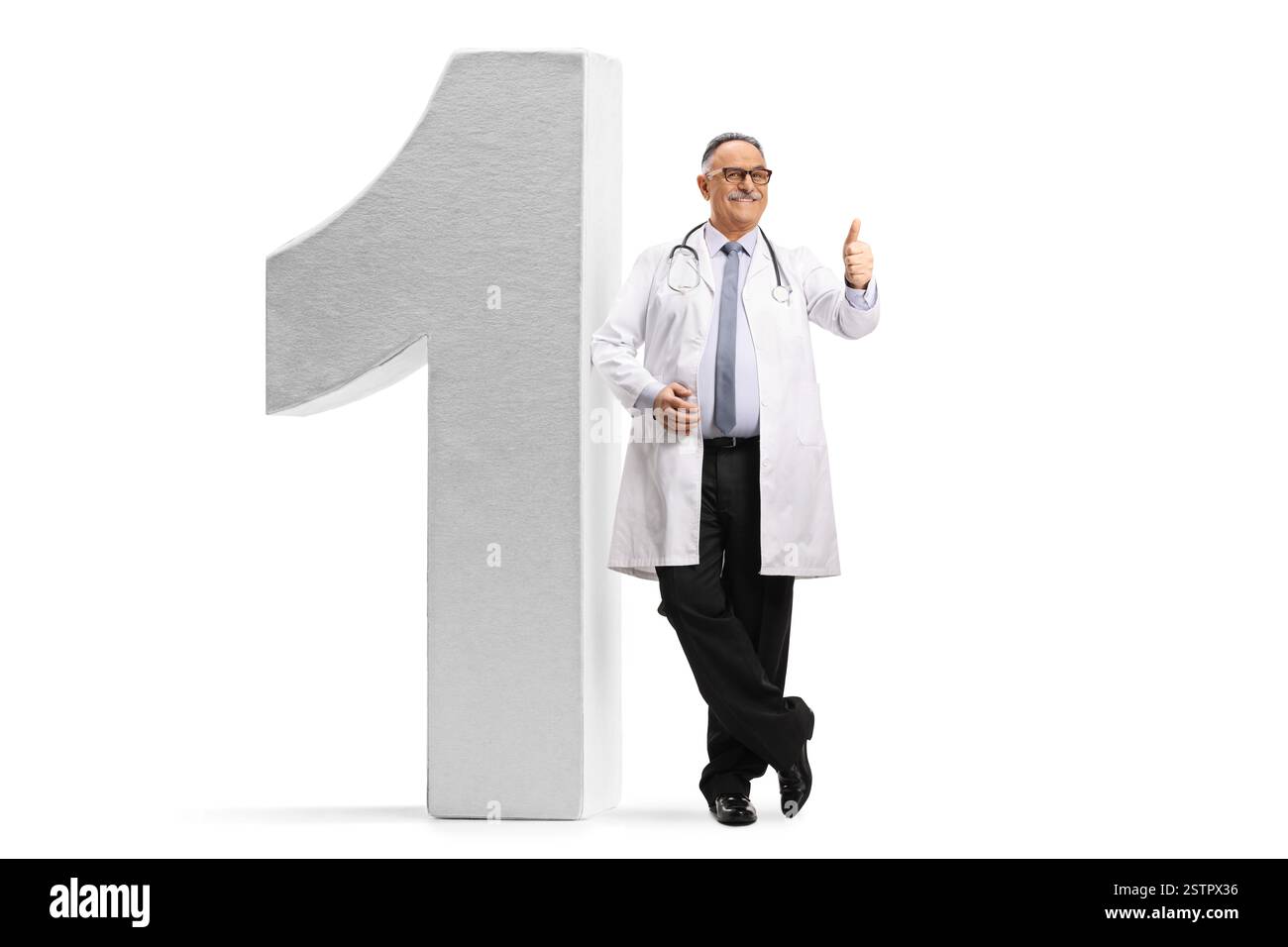 Mature male doctor gesturing thumbs up and leaning on a big number one ...