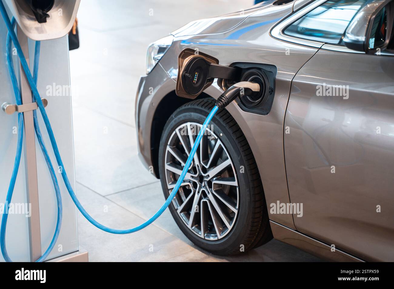Power supply plugged into an electric car being charged Stock Photo - Alamy