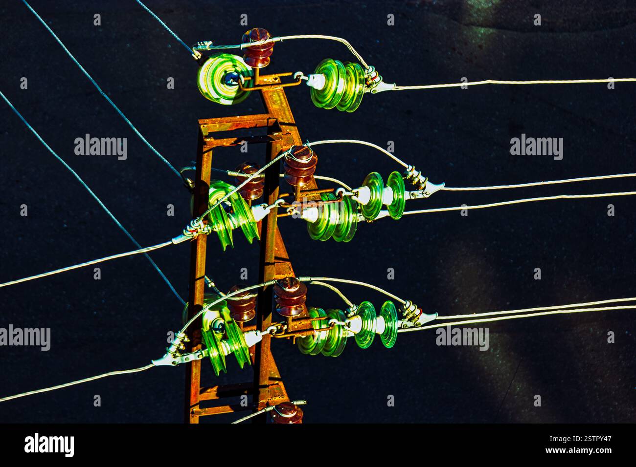 High voltage power tower detail with set of glass electrical insulators ...