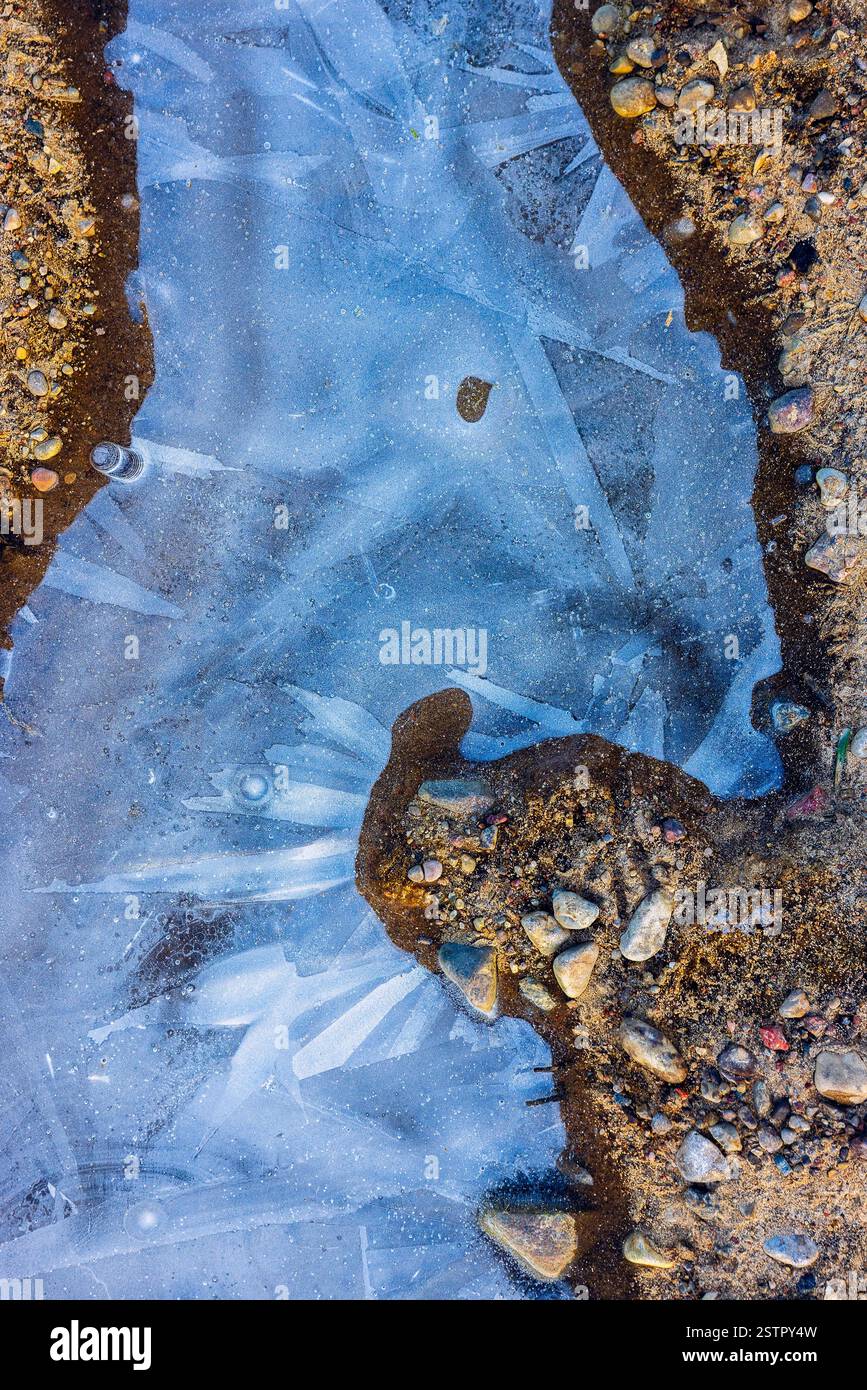 Frozen water on the ground, pattern of ice Stock Photo - Alamy