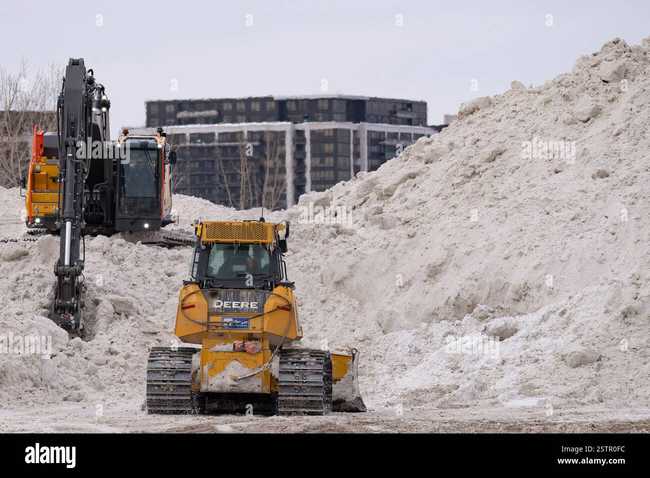 Toronto, Canada. 19th Feb, 2025. City crews work at a snow storage and ...