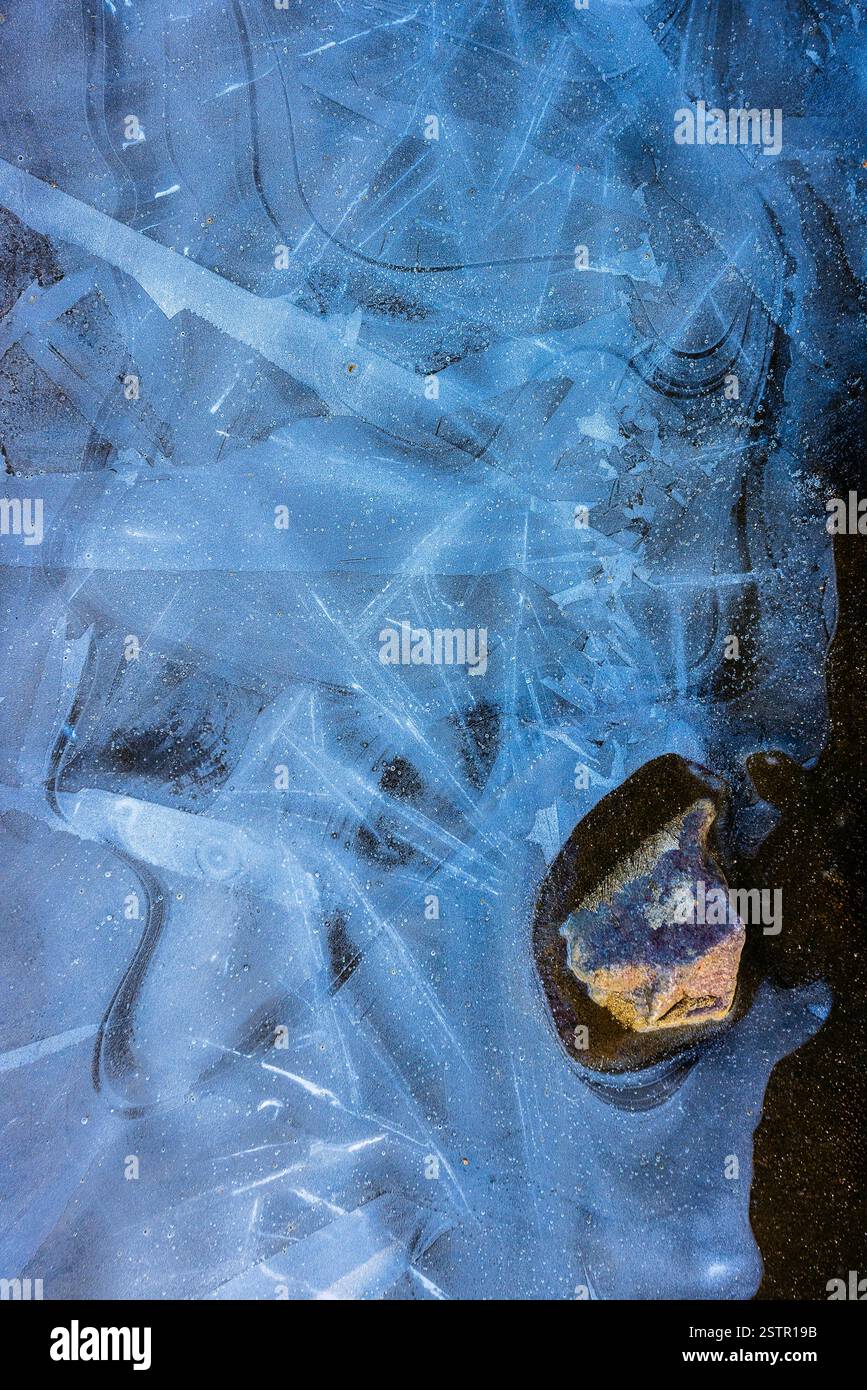 Frozen water on the ground, pattern of ice Stock Photo - Alamy