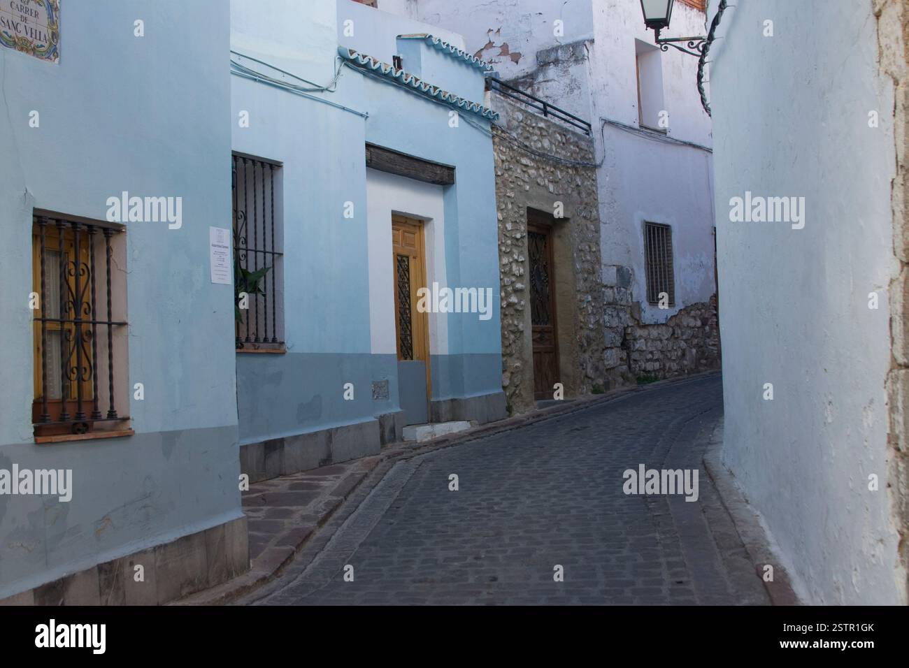 Narrow street in a town, featuring traditional architecture ...