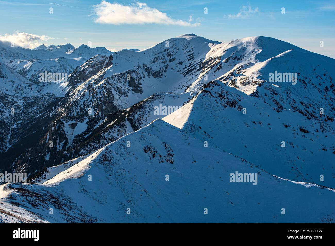 the line of peaks in the Tatra Mountains goes from left to right across ...