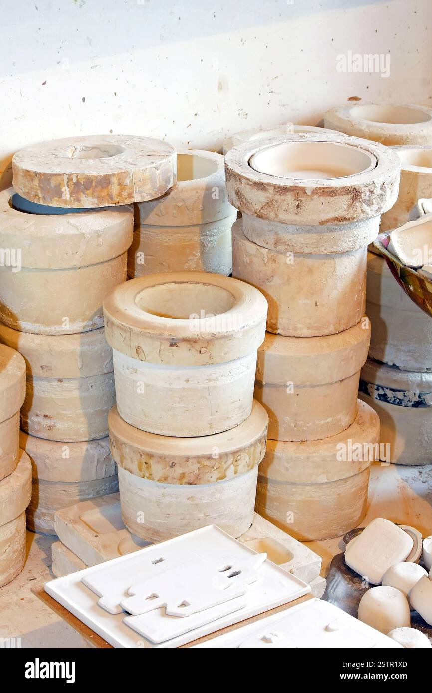 Ceramic production work bench with blank pottery Stock Photo - Alamy