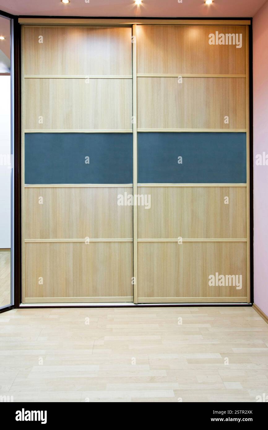 Double light wood wardrobe doors in wardroom hi-res stock photography ...
