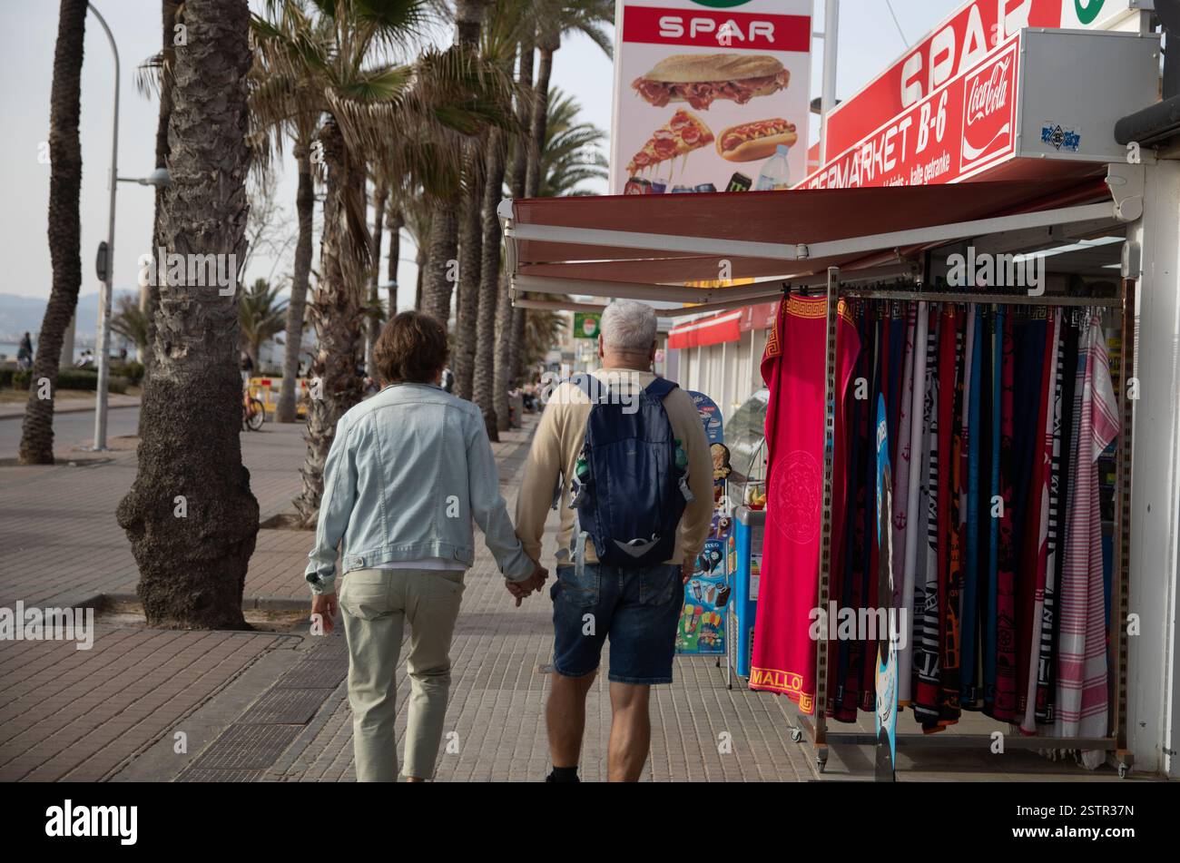 Palma, Spain. 19th Feb, 2025. People walk past a supermarket on the ...