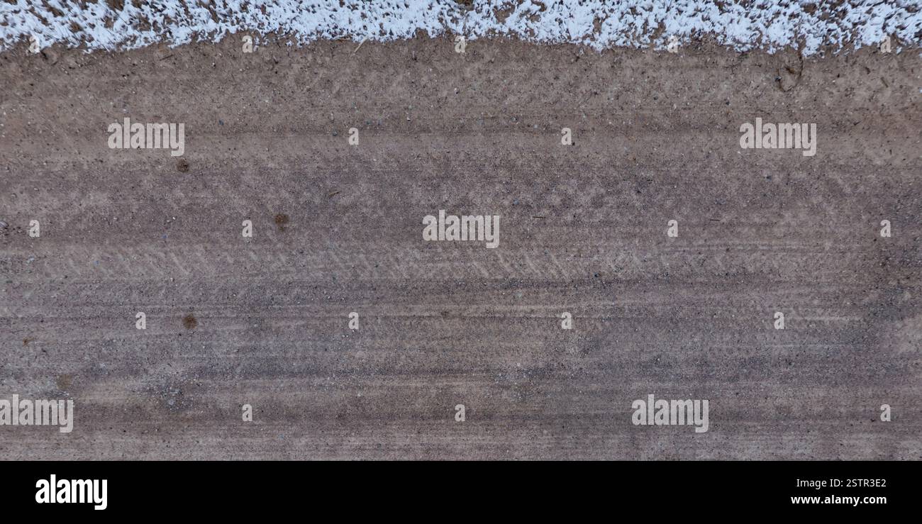 view from above on texture of dry road with tractor tire tracks in ...