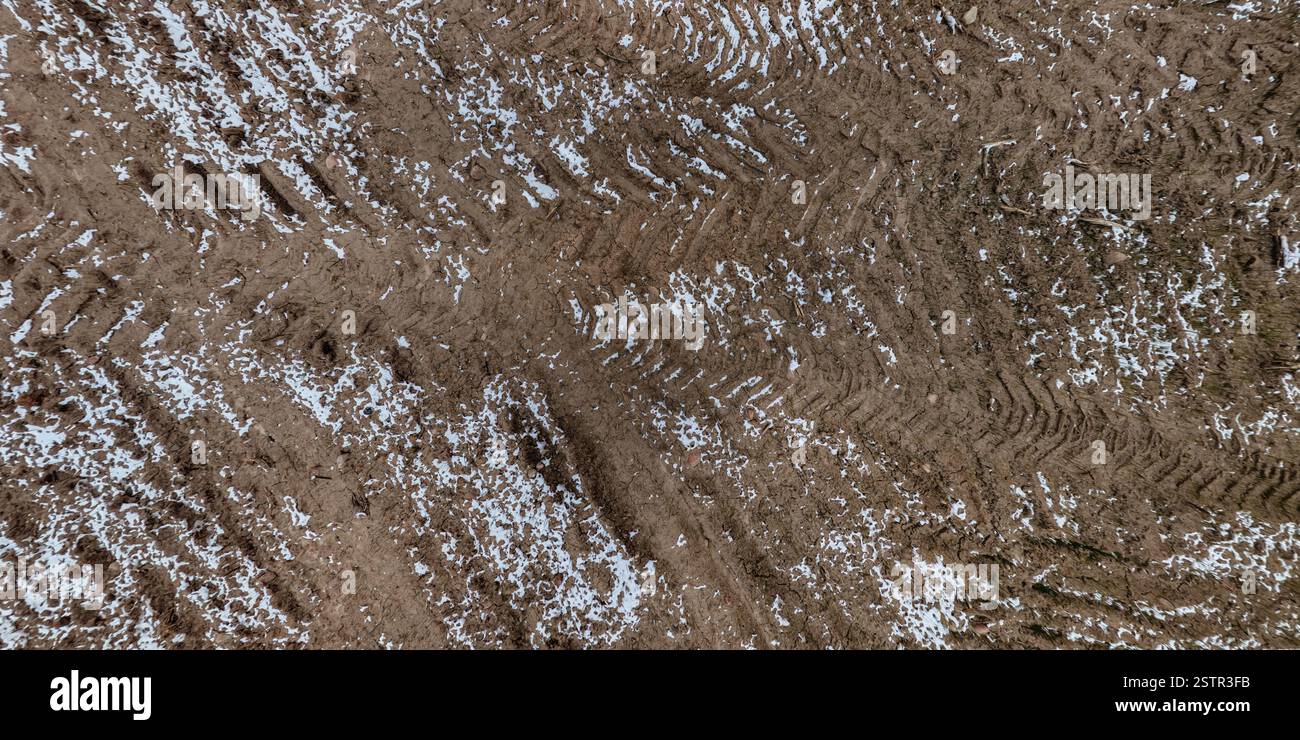 view from above on texture of dry road with tractor tire tracks in ...