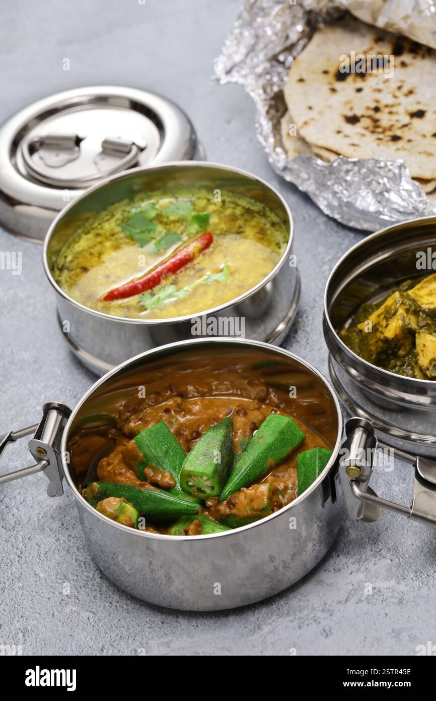 A retro Indian lunch box filled with vegetarian food. And chapati Stock ...