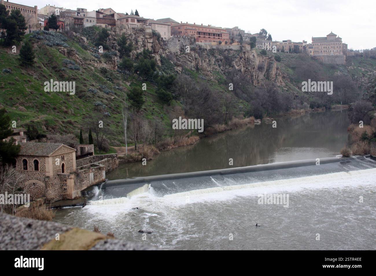 Town built on cliffs overlooking a river and dam. Landscape, water ...