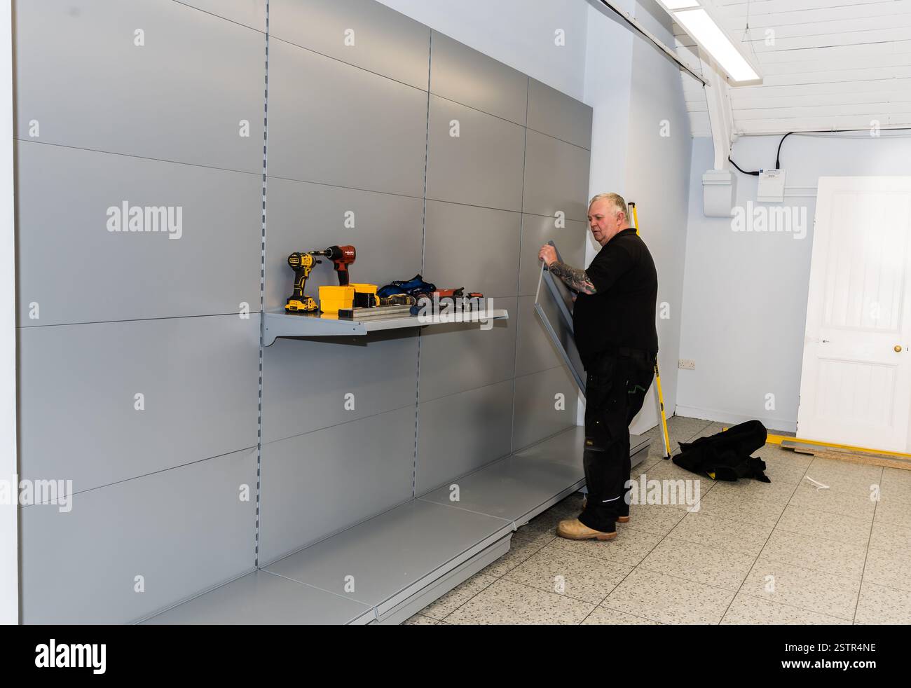 Lord Clinton cuts the ribbon and declares the shop open once more Stock ...
