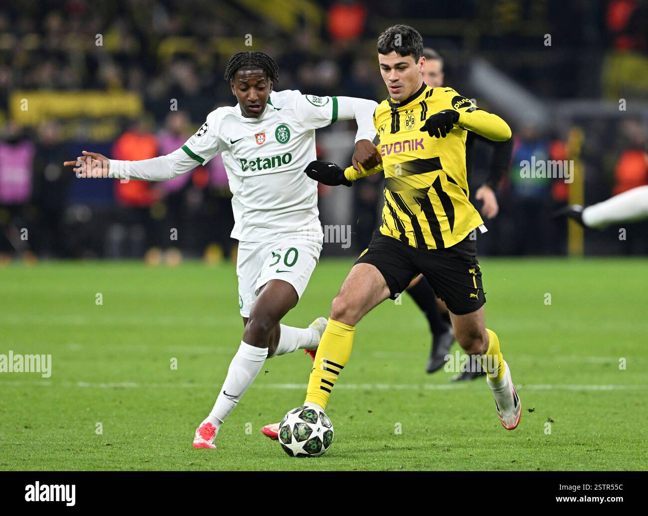 Dortmund's Giovanni Reyna, right, dribbles ahead of Sporting's ...